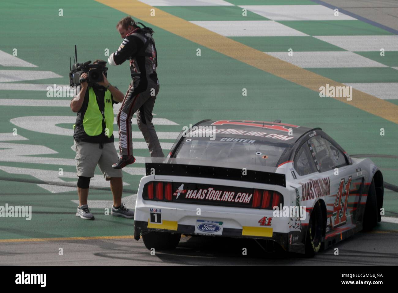 Cole Custer, top, celebrates after winning a NASCAR Cup Series auto ...