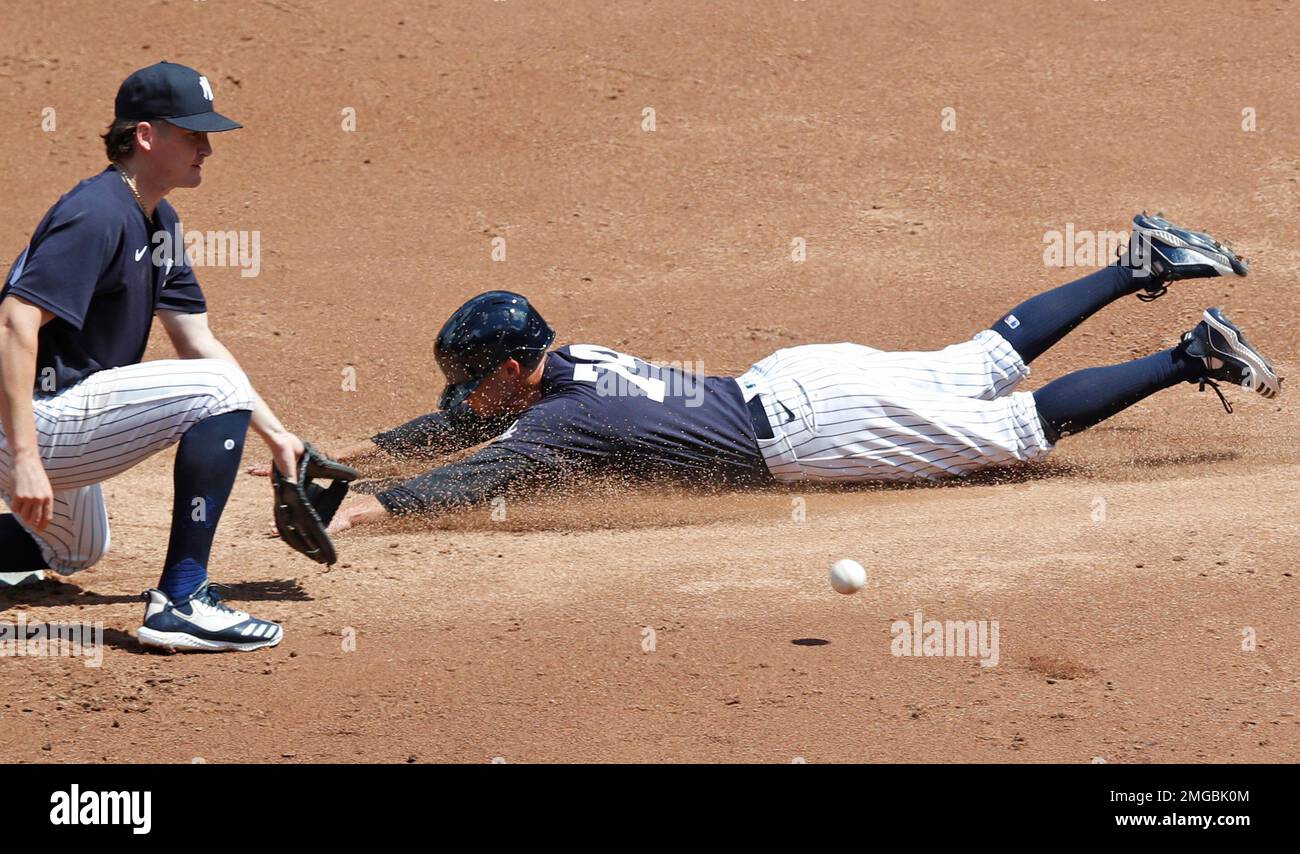 New York Yankees' Zack Granite, right, slides safely into second on a ...