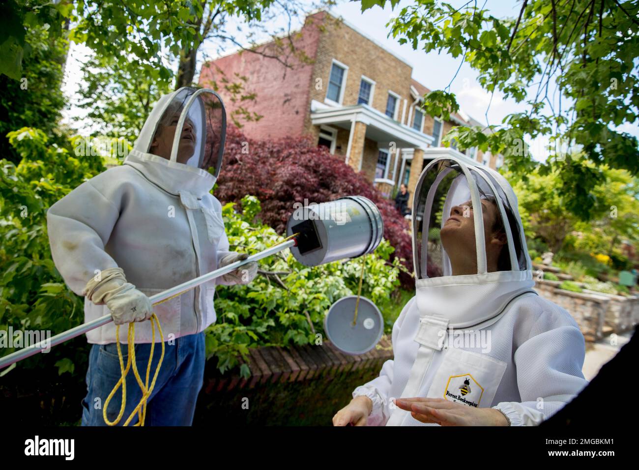 Beekeepers Sean Kennedy, left, and Erin Gleeson, right, prepare to ...