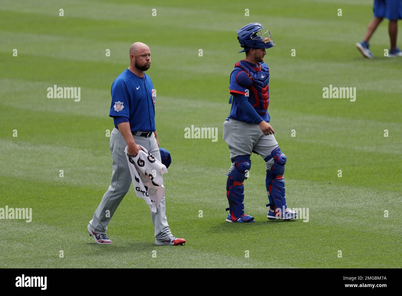 Chicago Cubs pitcher Jon Lester, left, walks with catcher P.J. Higgins ...