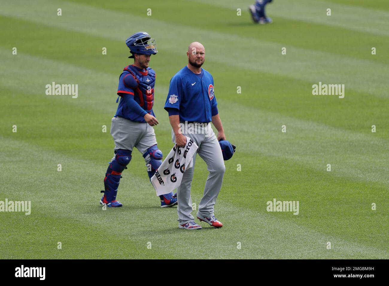 Chicago Cubs pitcher Jon Lester, right, and catcher P.J. Higgins walk ...