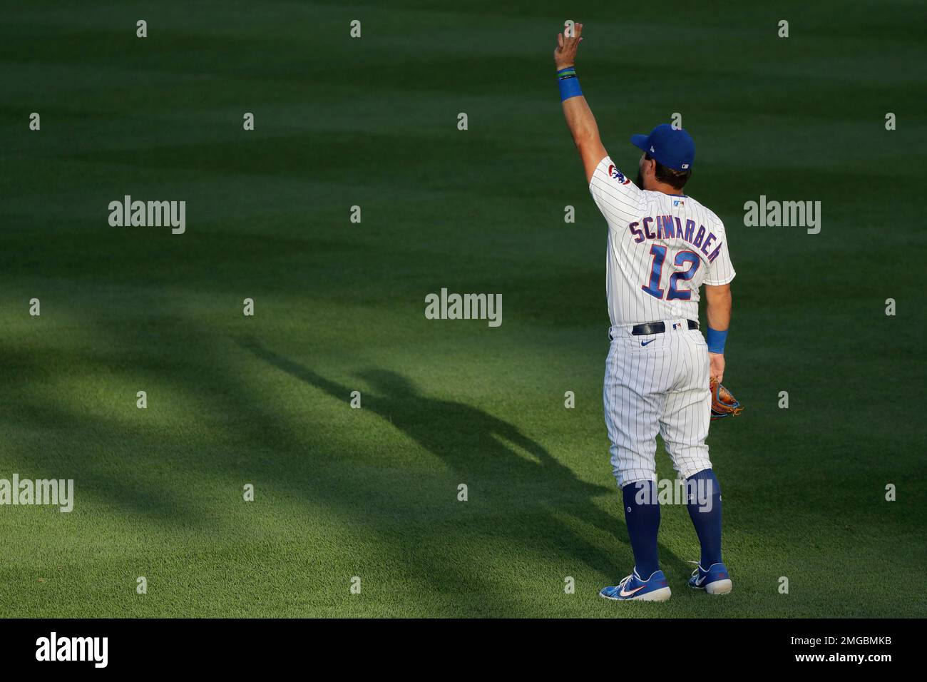Chicago Cubs outfielder Kyle Schwarber waves during baseball practice ...