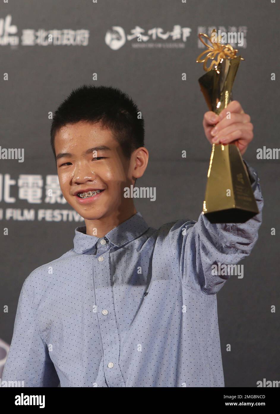 Taiwanese actor Li Ying-chuan holds his awards for Best Supporting ...