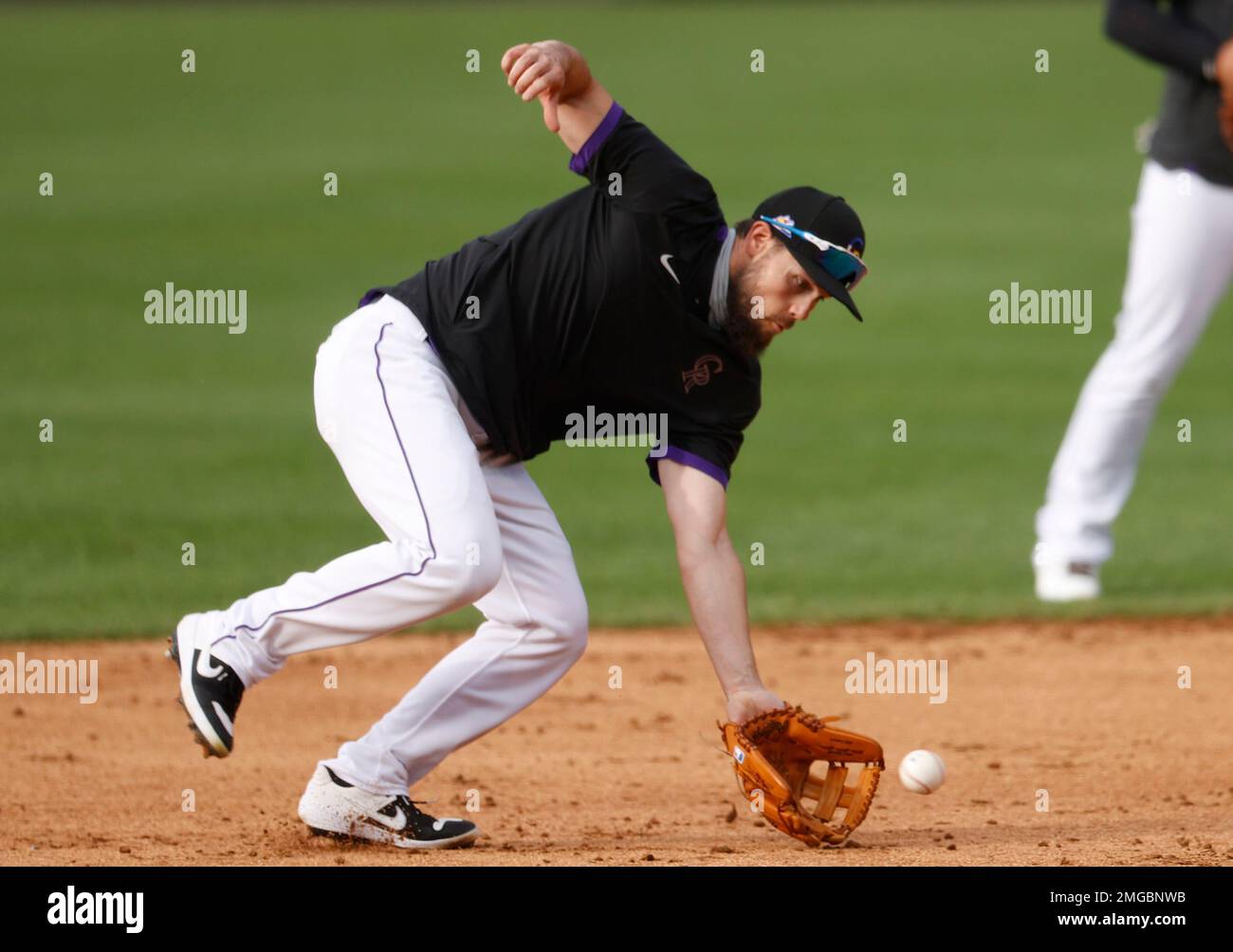 Colorado Rockies utility infielder Chris Owings fields a ground ball ...