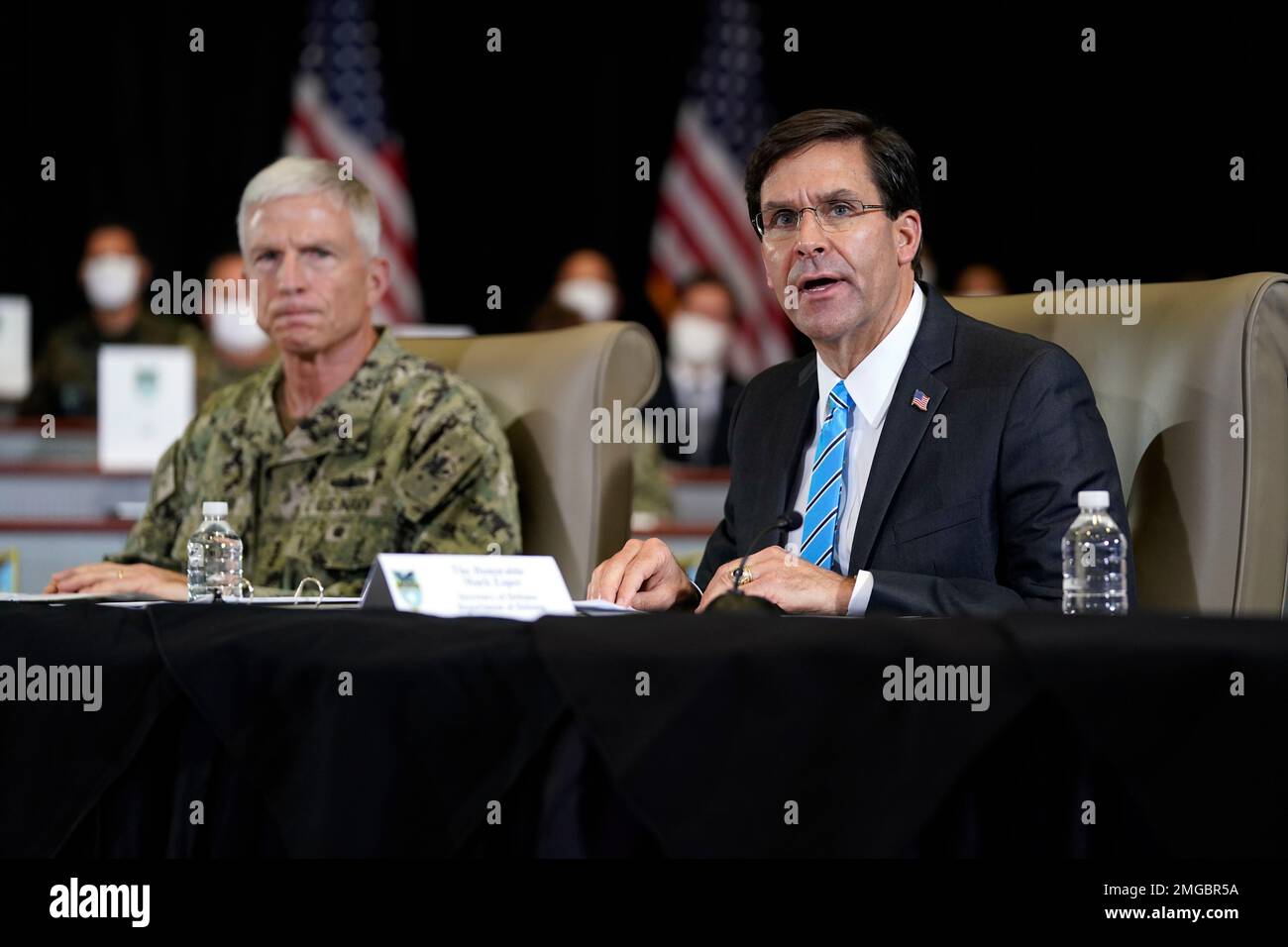 U.S. Navy Adm. Craig Faller, left, listens as Defense Secretary Mark ...