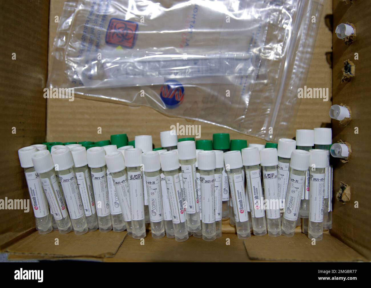 Coronavirus testing kits sit in a box at a drive-thru coronavirus ...