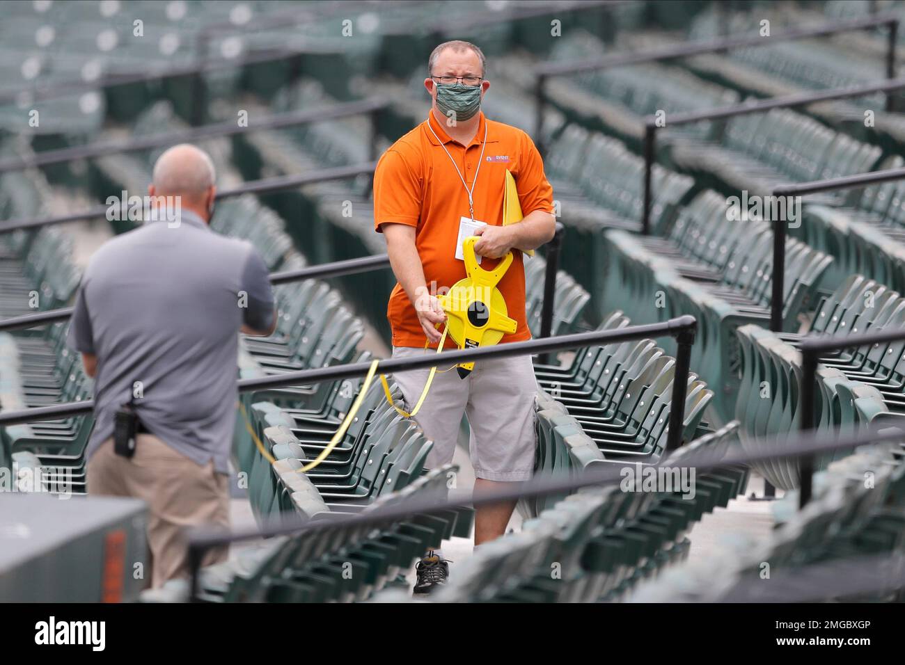 Baltimore Orioles workers measure the seating area behind the first ...