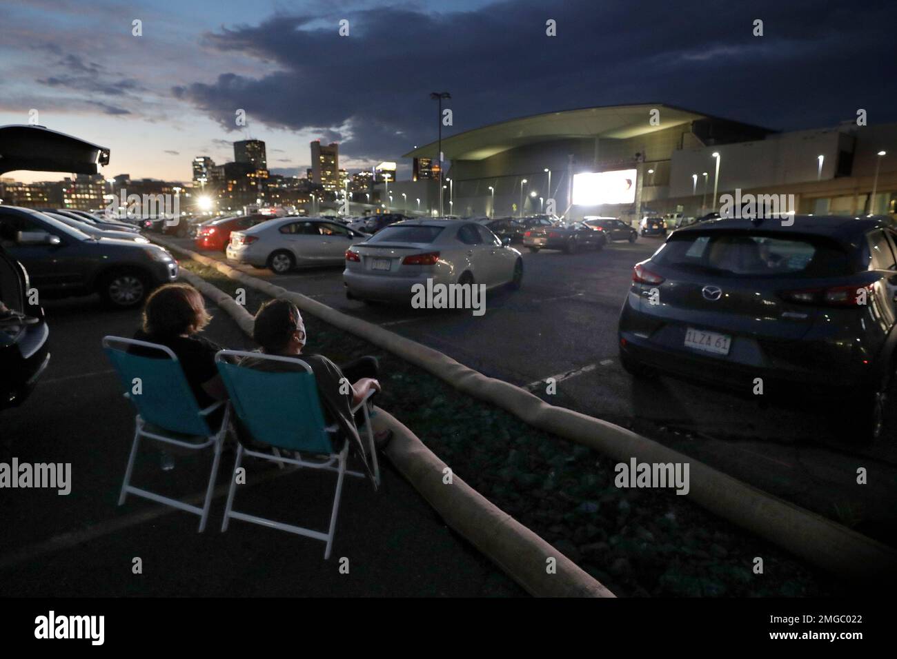 People attend a drive-in movie screening of the film "Yesterday ...