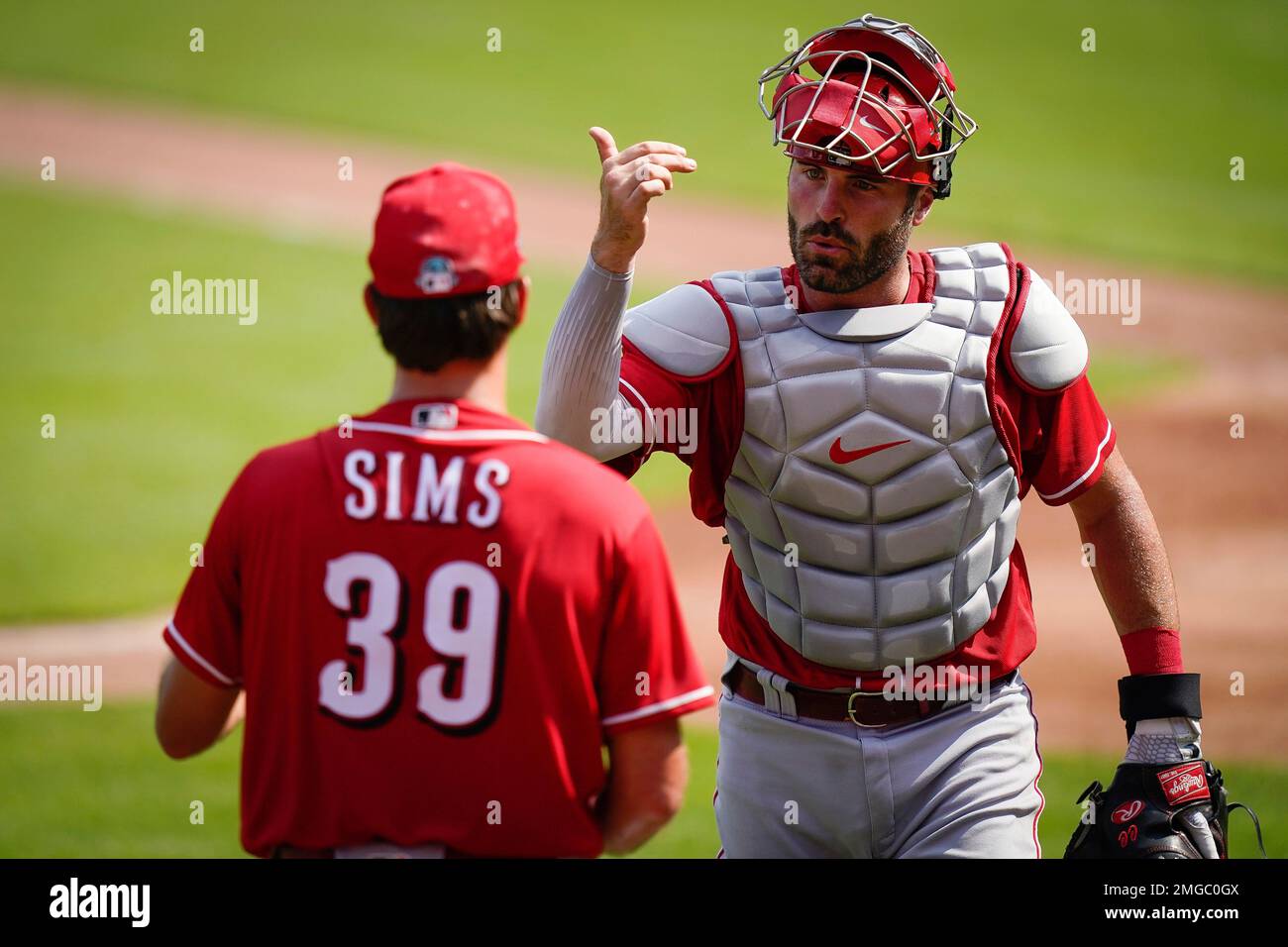 Cincinnati Reds catcher Curt Casila speaks with pitcher Justin Sims ...