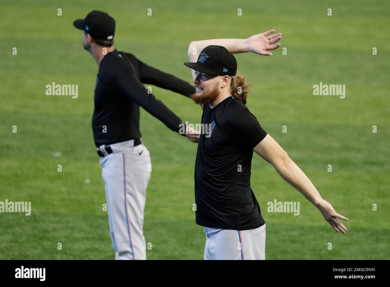 Miami Marlins relief pitcher Ryne Stanek, right, stretches during ...