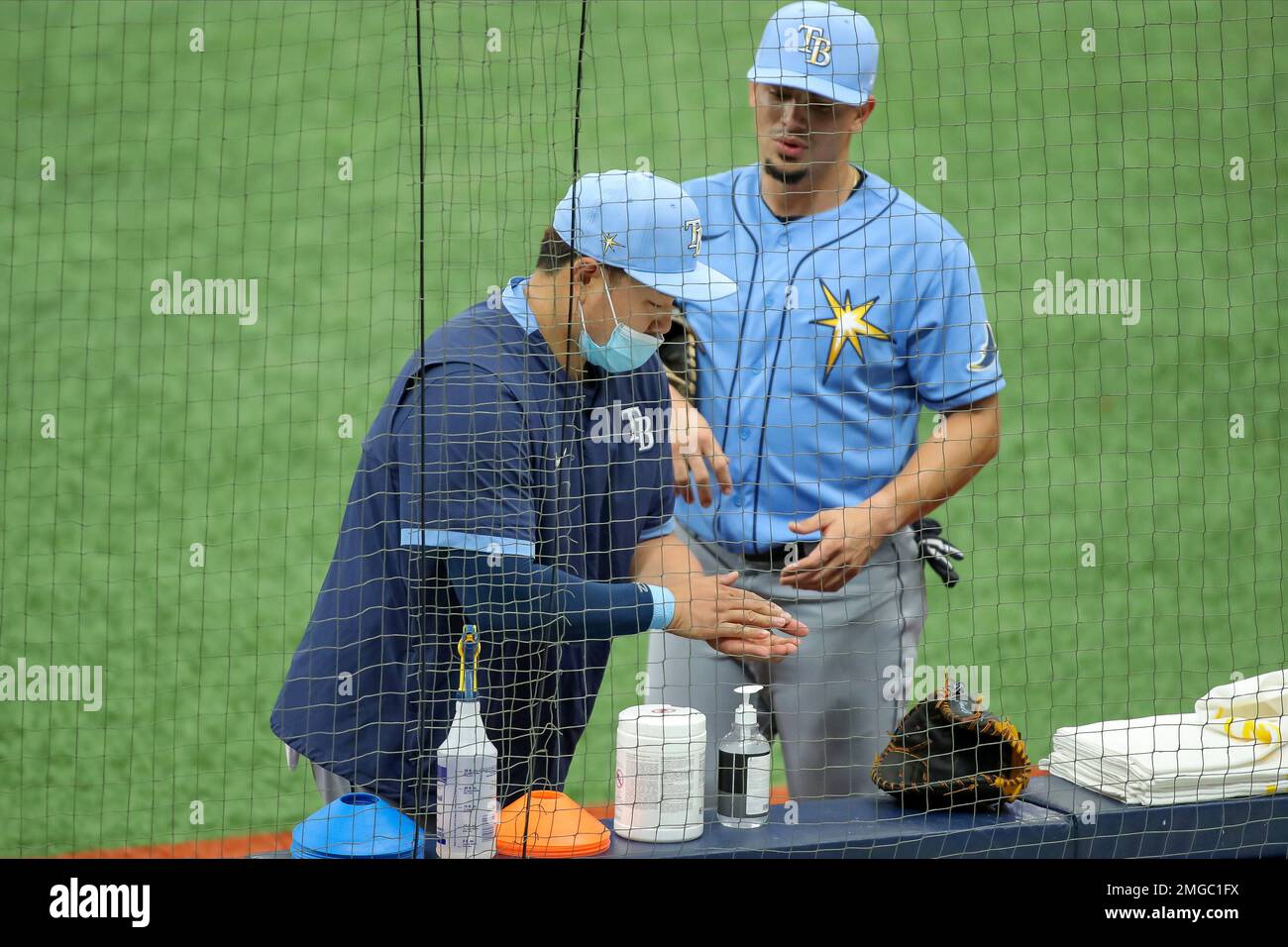 Tampa Bay Rays' Ji-Man Choi, left, and Willy Adames get hand sanitizer ...