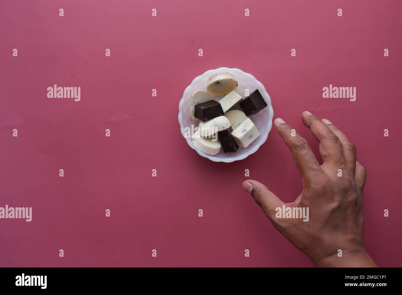 hand reach for dark chocolate on a plate Stock Photo - Alamy