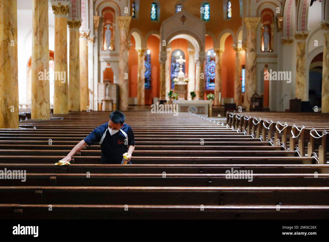 Pews are sanitized after Spanish-language Mass at Saint Bartholomew ...