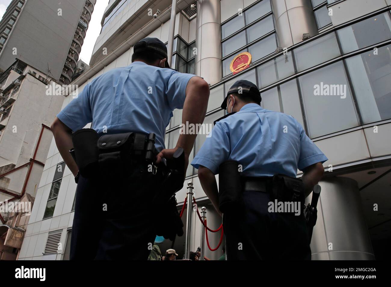 Police officers stand guard outside China's new Office for Safeguarding ...
