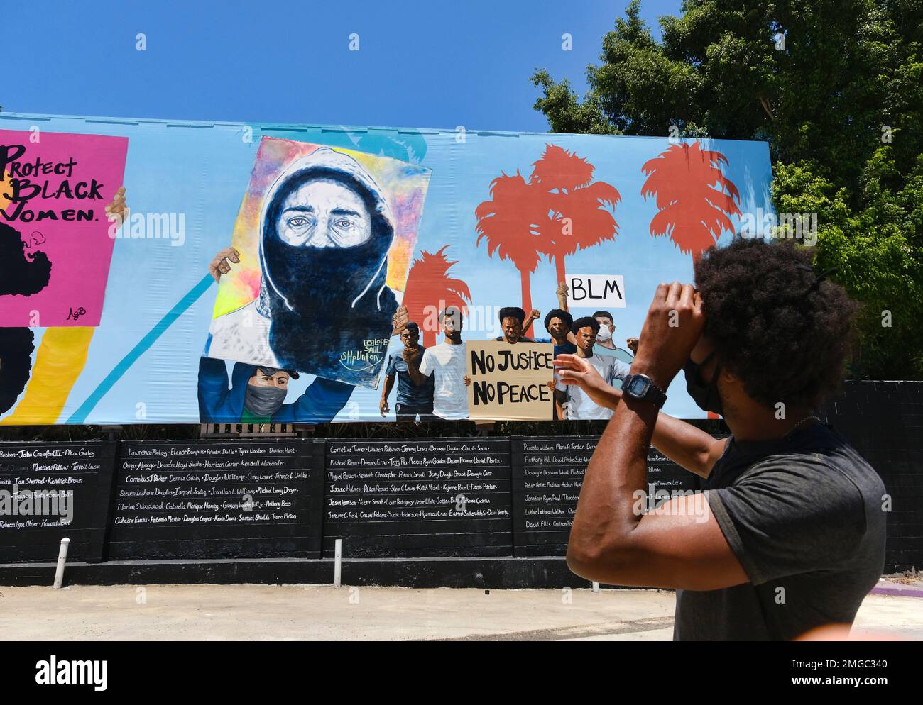 Artist who goes by the name Shplinton points to a section of mural he ...