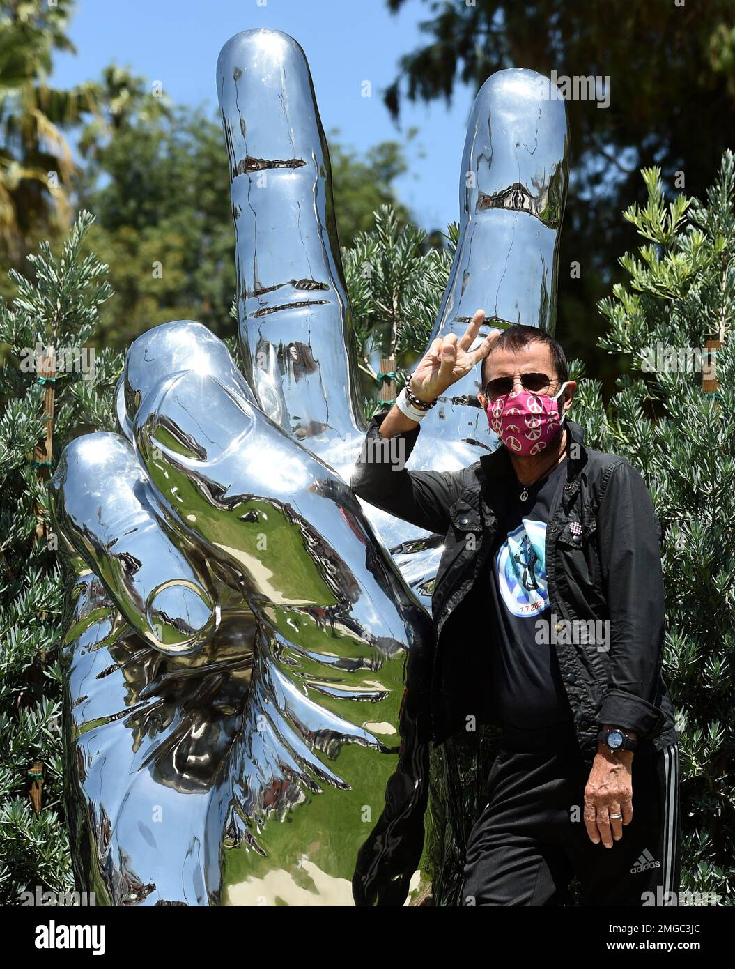 Musician Ringo Starr poses in front of his "Peace and Love" public ...