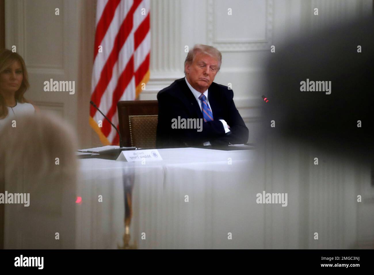 President Donald Trump is reflected in a mirror during a "National ...