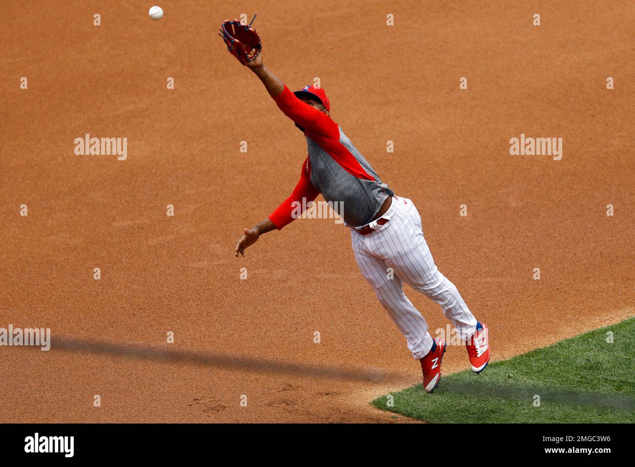 Philadelphia Phillies' Jean Segura leaps for a ball during baseball ...