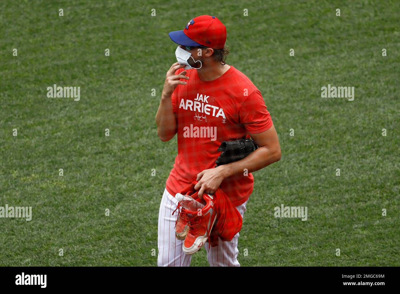 Philadelphia Phillies' Aaron Nola adjusts his mask during baseball ...