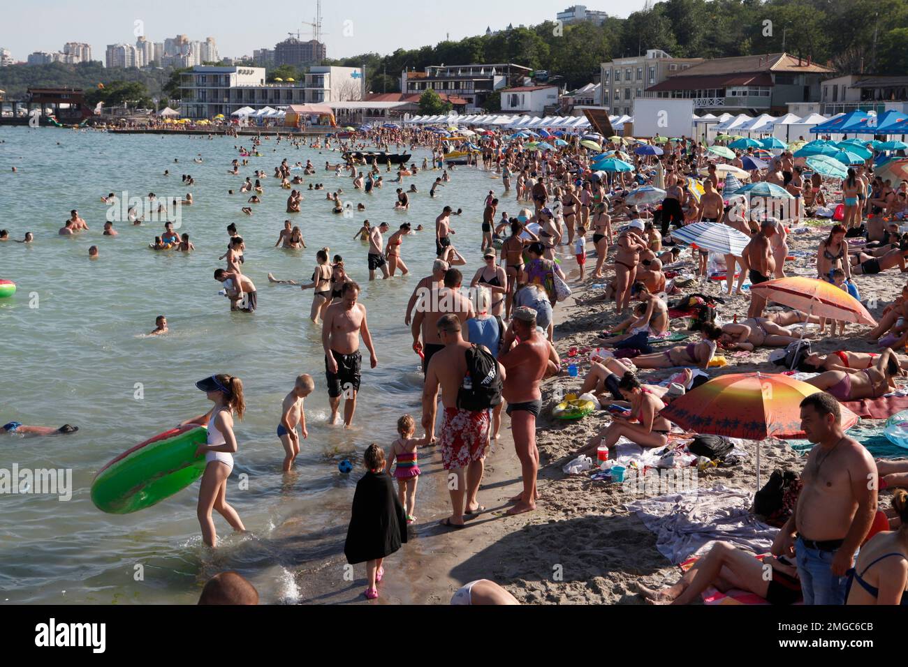 People enjoy the beach in the Black Sea in Odessa, Ukraine, Saturday ...