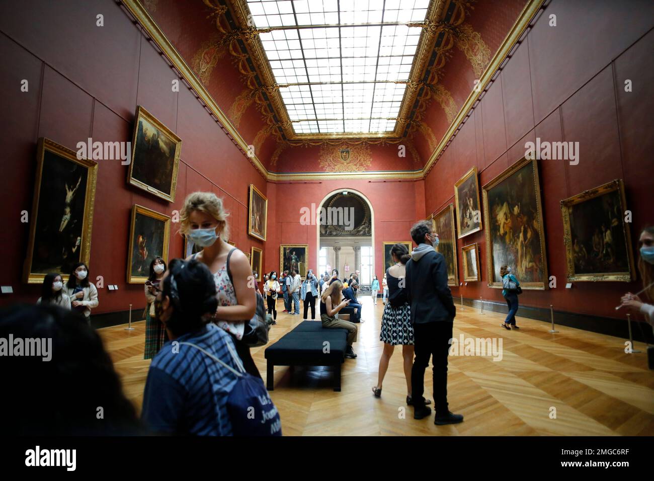 Visitors watch pantings at the Louvre Museum, in Paris, Monday, July 6 ...