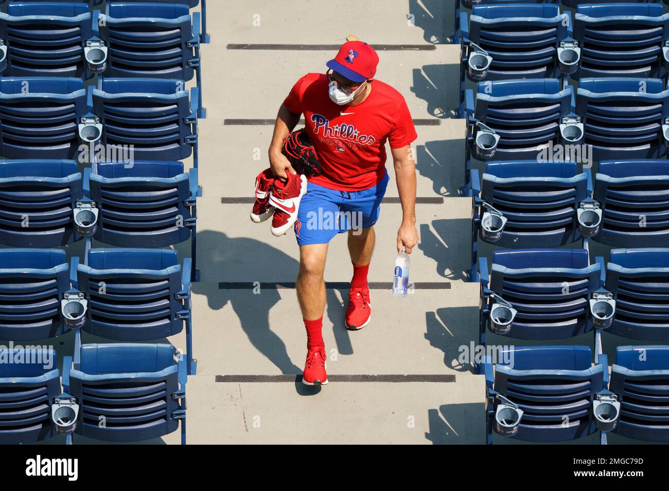 A Philadelphia Phillies heads up the aisle before a baseball training ...