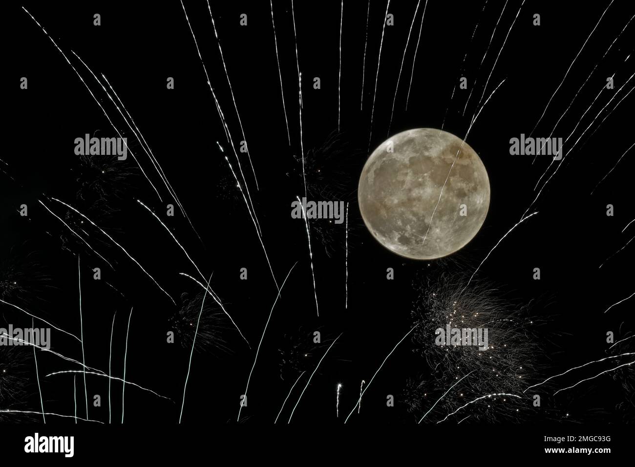 A Fourth of July fireworks display lights up the sky as the full moon ...