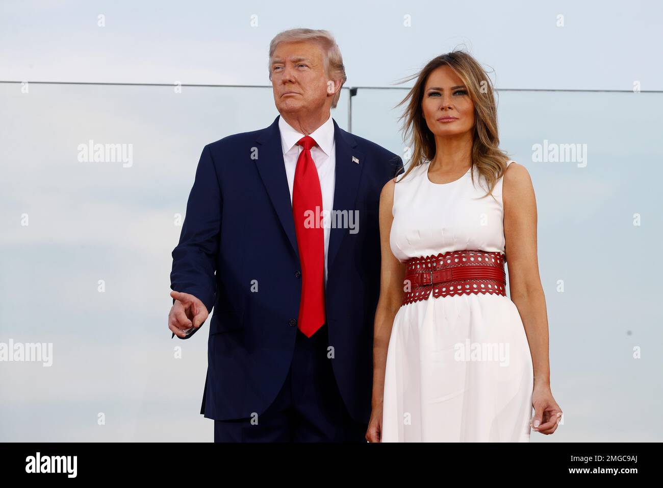 President Donald Trump and first lady Melania Trump stand onstage ...