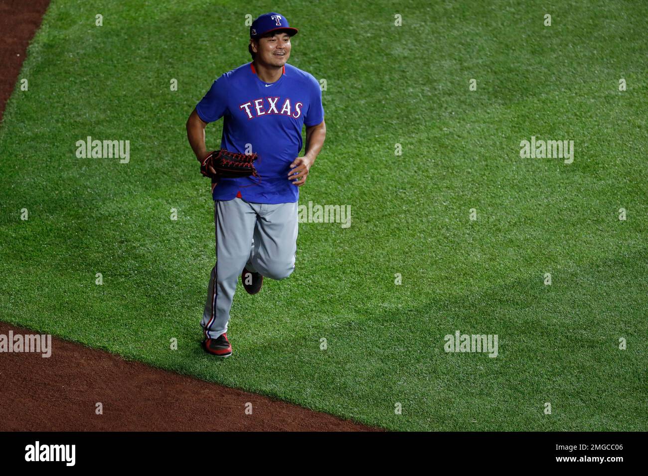 Texas Rangers outfielder Shin-Soo Choo smiles after fielding a fly ball ...