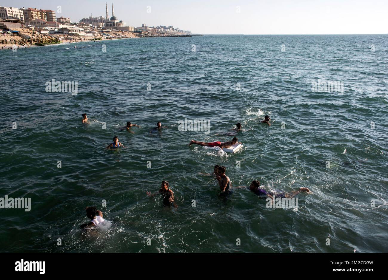 Palestinians enjoy a sunny summer day on the beach of Gaza City, Friday ...