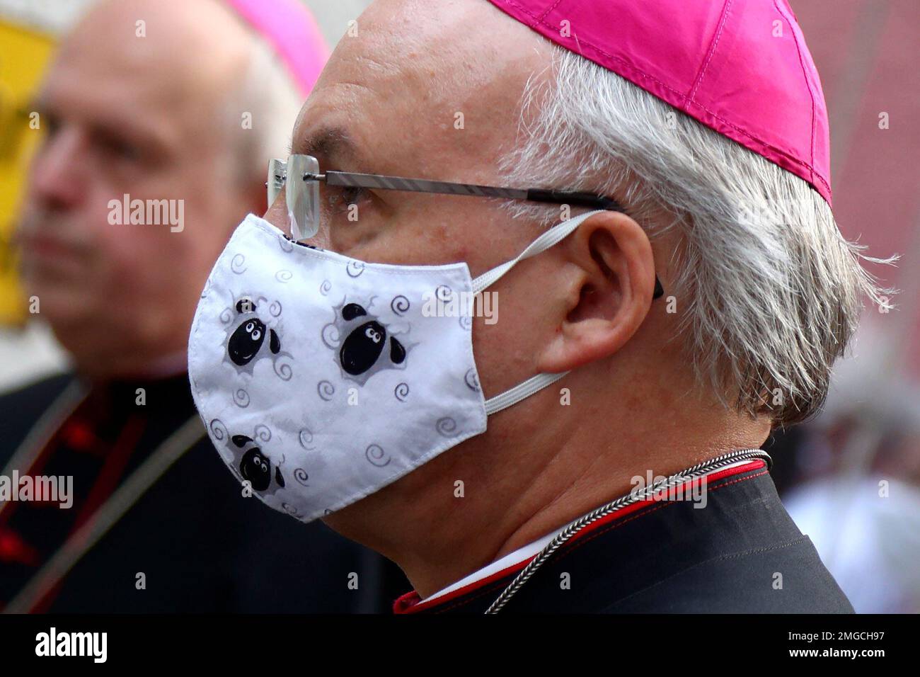 Rudolf Voderholzer, bishop of Regensburg, wears a face mask as he ...