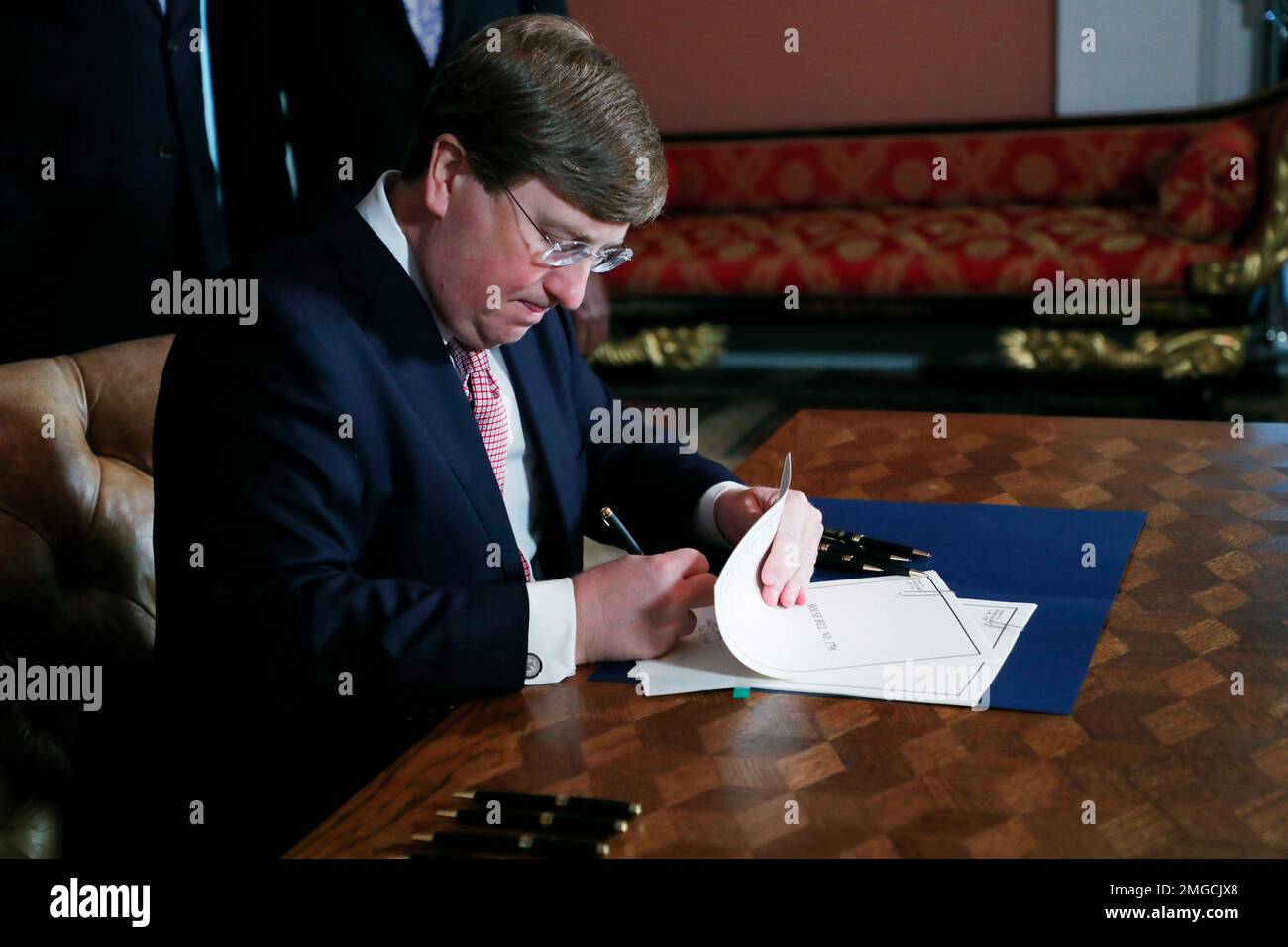 Mississippi Gov. Tate Reeves signs the bill retiring the last state ...