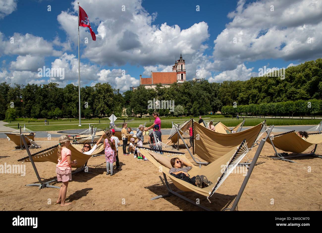 People sunbathe on an artificial beach in Vilnius, Lithuania, Tuesday ...