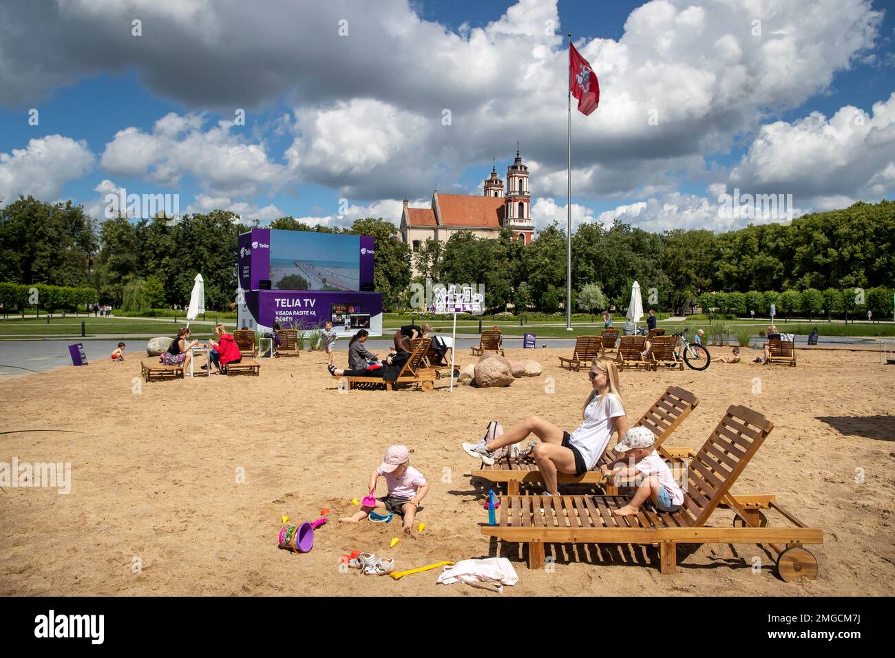 People sunbathe on an artificial beach in Vilnius, Lithuania, Tuesday ...