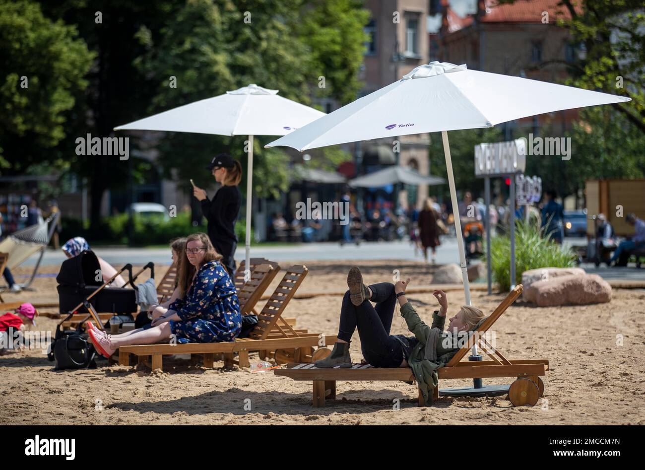 People sunbathe on an artificial beach in Vilnius, Lithuania, Tuesday ...