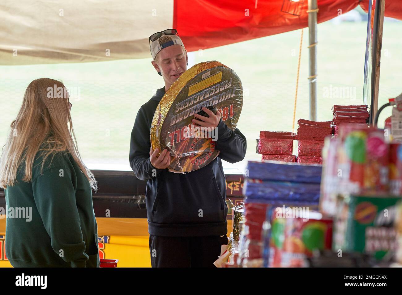 Shoppers read the label on a giant package of firecrackers, at Wild ...