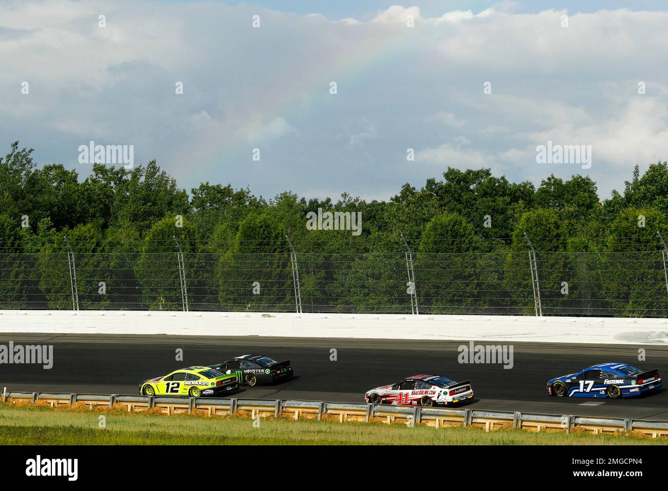 Cars make their way around the track during caution laps under a ...