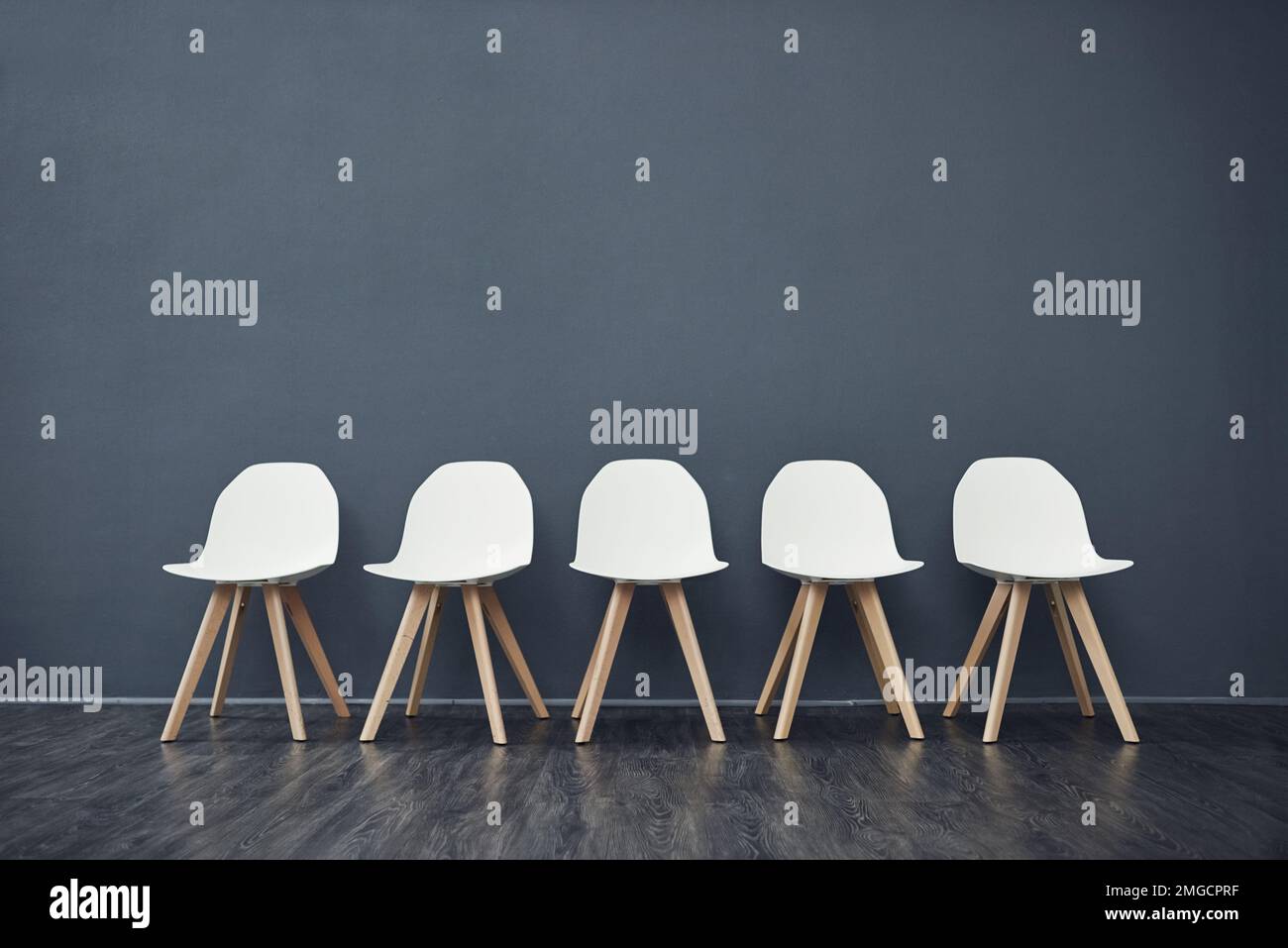 Weve got spots available. a row of empty chairs against a grey ...