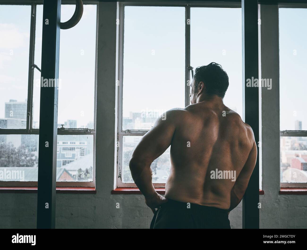 Getting in shape is whats best for you. Rearview shot of a muscular man ...