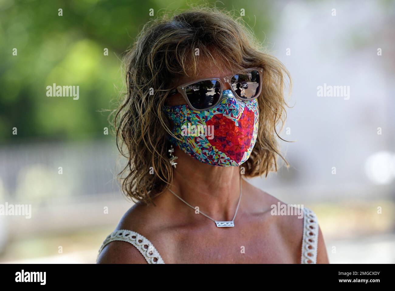 Resident Lisa Beebe wears a face covering in downtown Raleigh, N.C ...