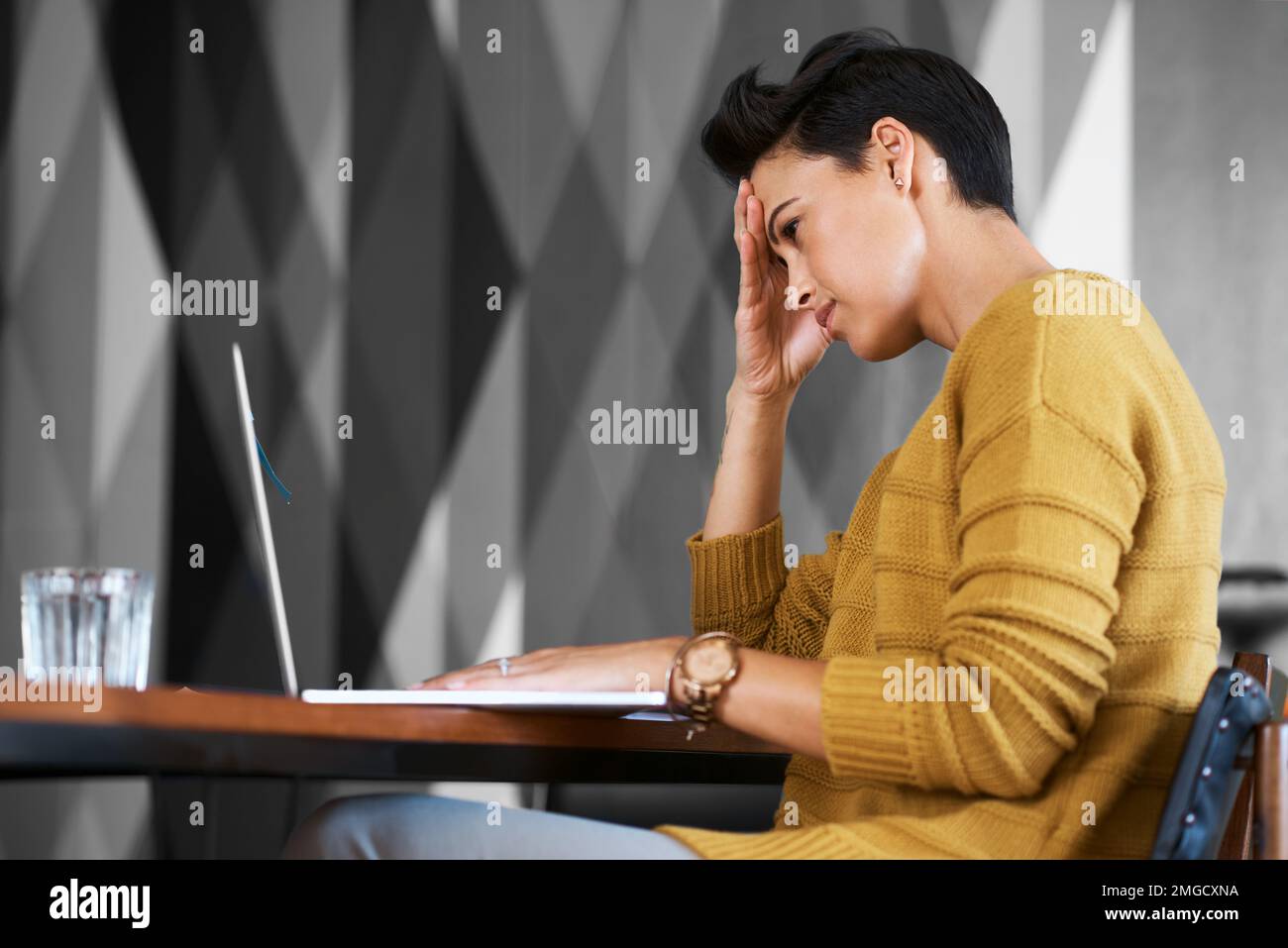 Feeling the pressure. an attractive young businesswoman looking ...