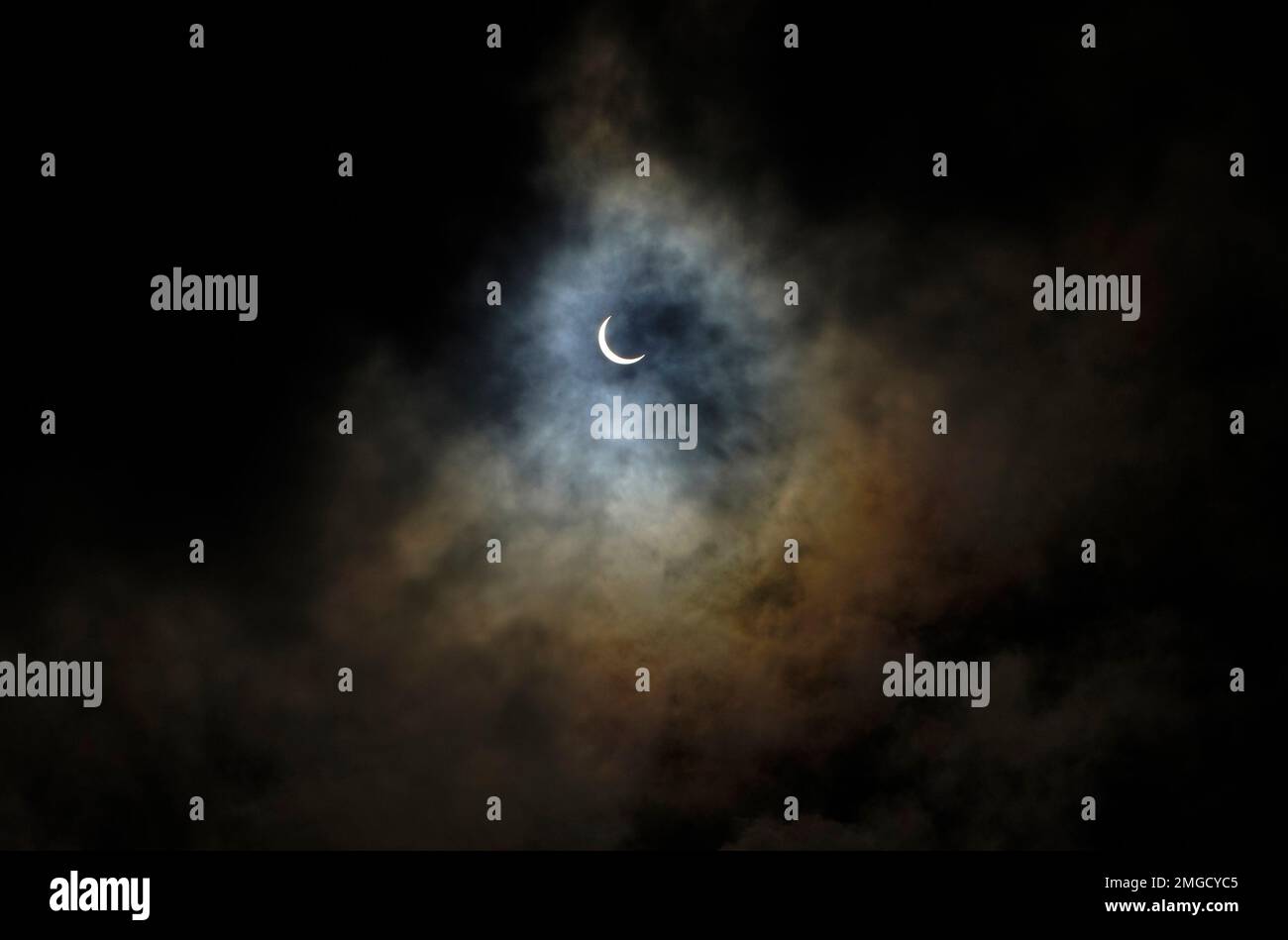 The sun is seen through rain clouds during solar eclipse in Hong Kong ...