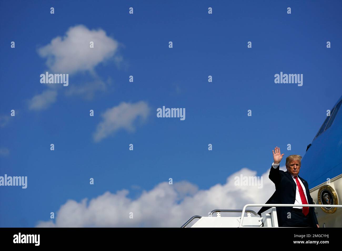 President Donald Trump waves as he boards Air Force One to depart Green ...