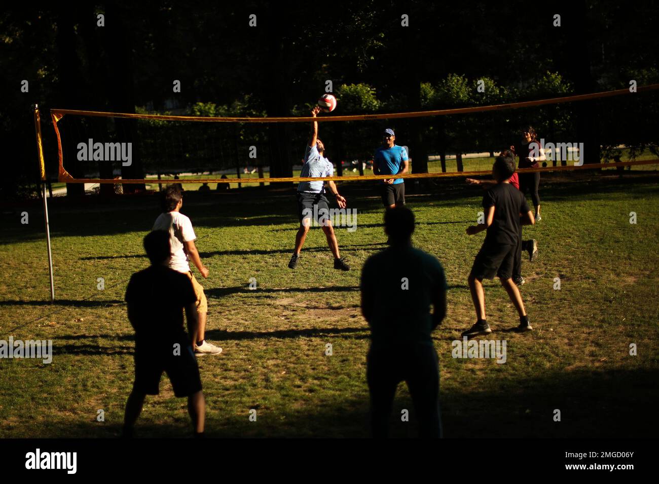 People play volleyball at the Cinquantenaire park on a hot summer day ...