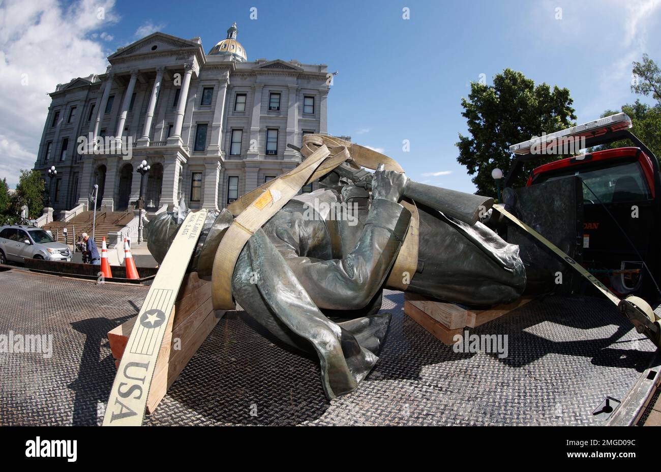 The Civil War Monument statue is strapped on the back of a flatbed tow ...