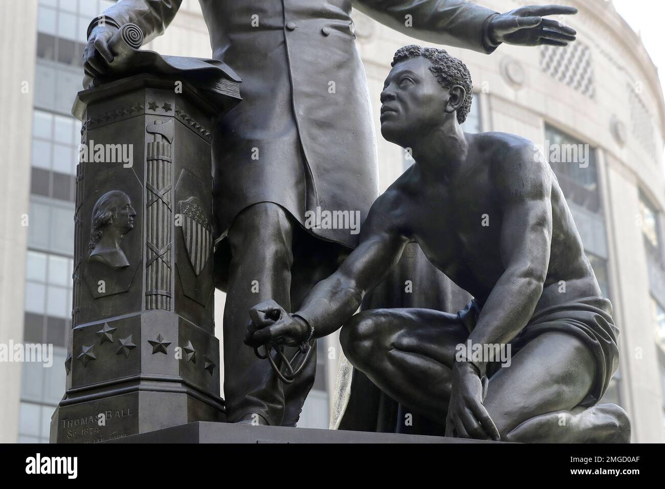 A detail of a statue that depicts a freed slave kneeling at Abraham ...