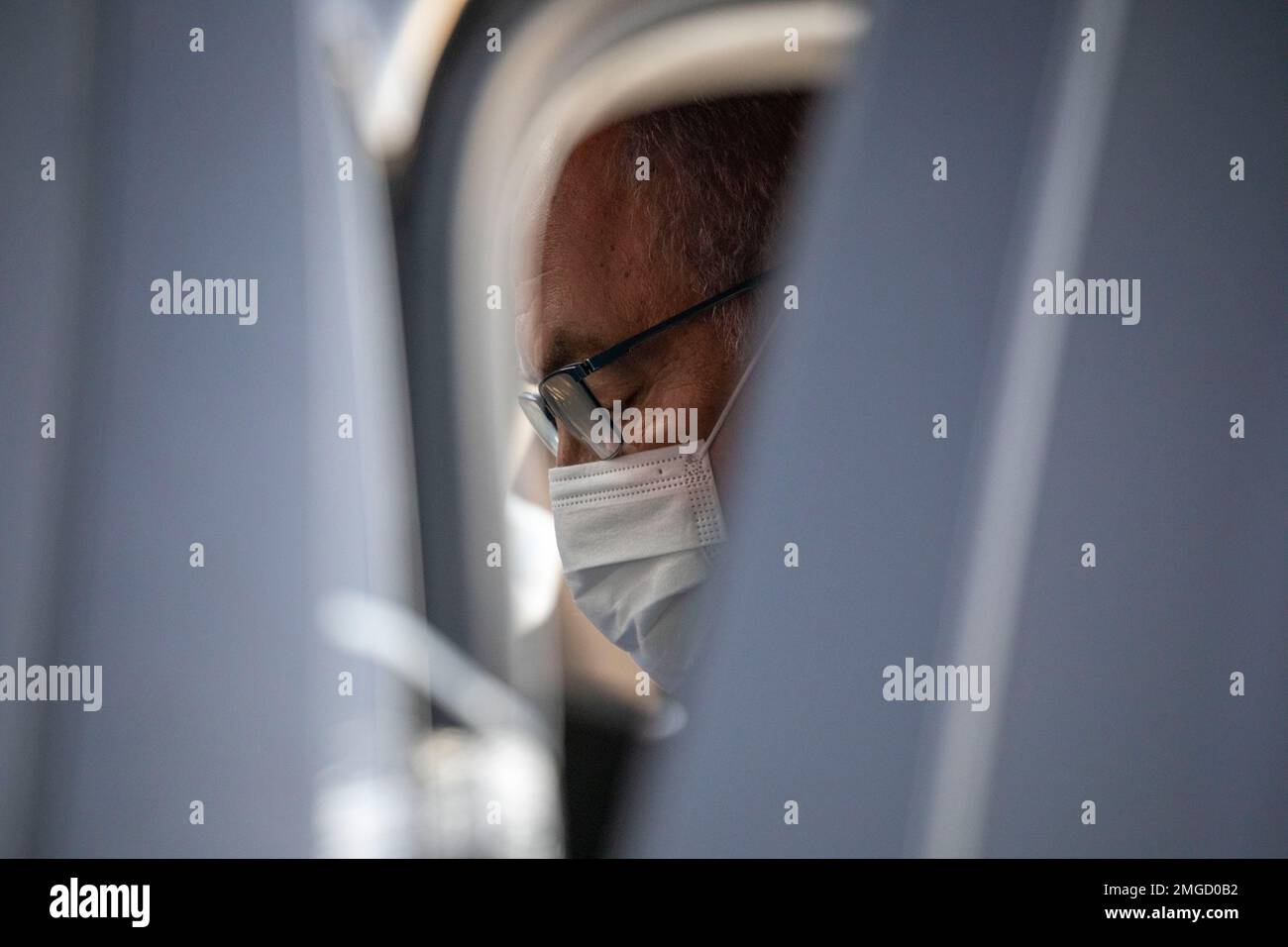 Israeli Prime Minister Benjamin Netanyahu wearing a face mask sits in ...