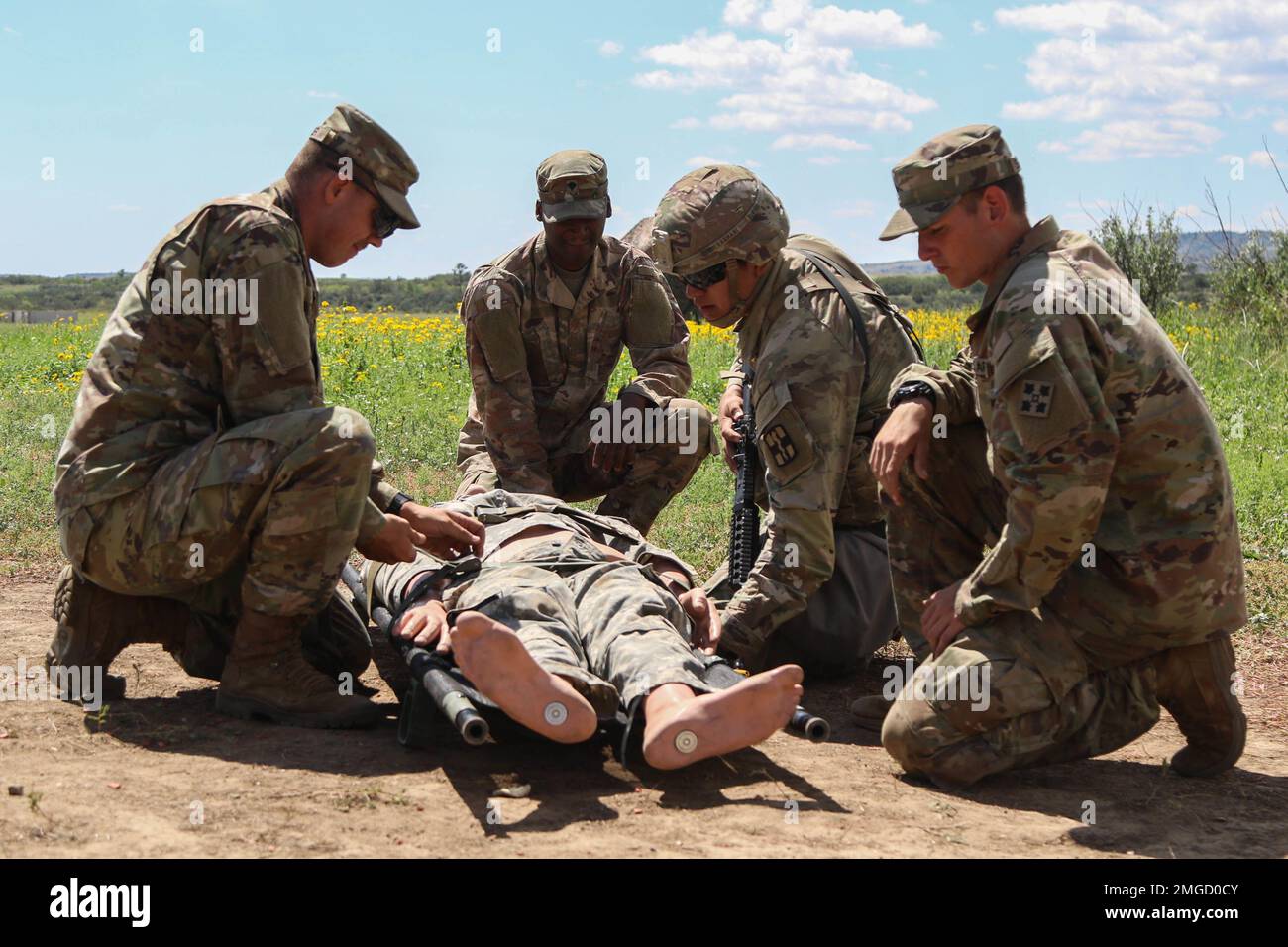 Soldiers assigned to the 4th Infantry Division assist an Expert Field ...