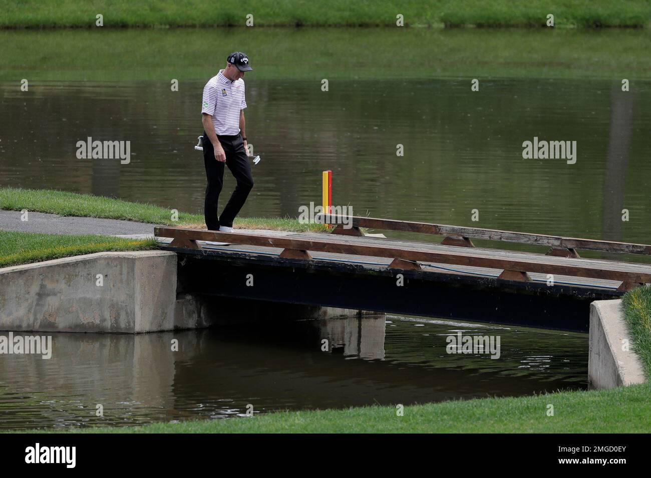 Jim Furyk walks on a bridge while heading to the 16th green during the ...