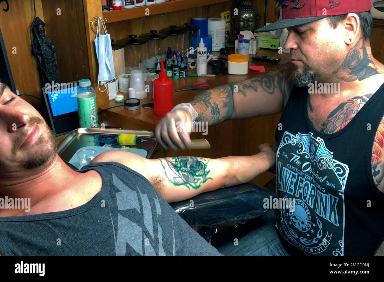 In this Friday, June 19, 2020, photo, tattoo artist Alexander Lawrence ...